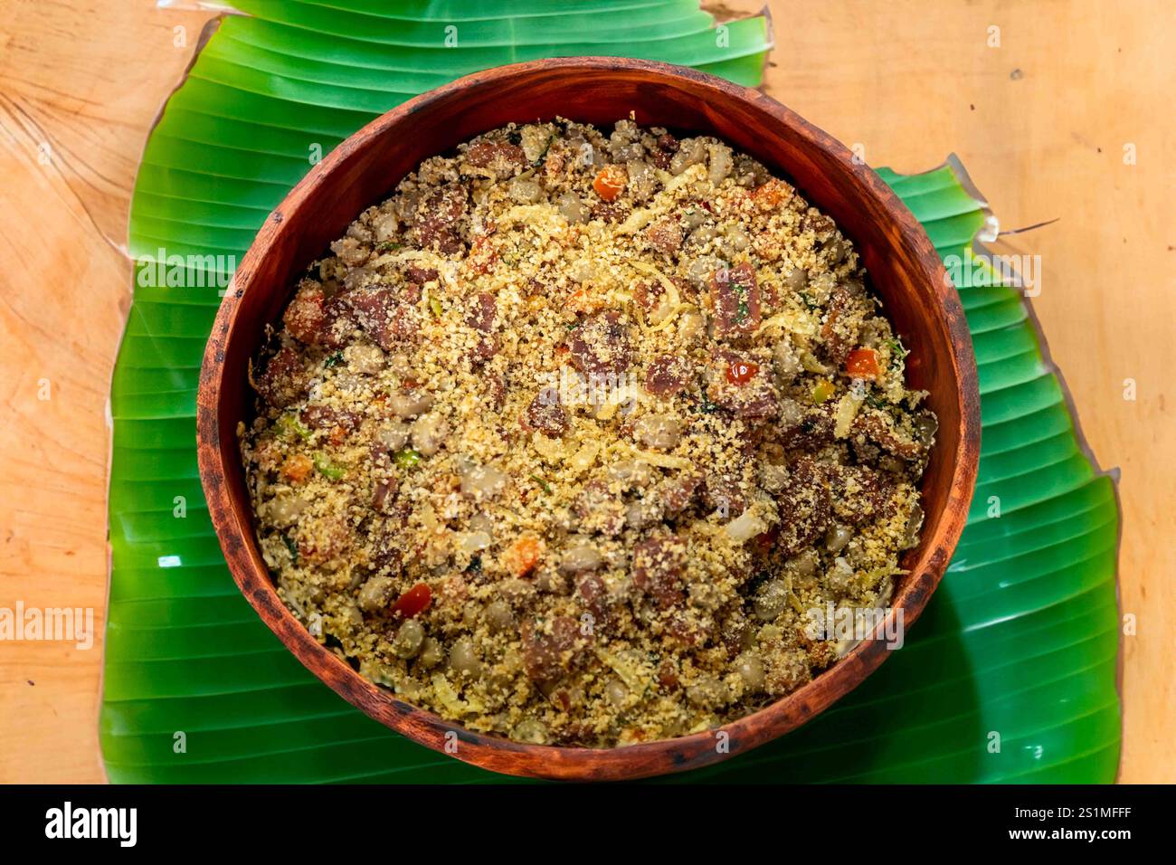 Traditional Brazilian farofa prepared with toasted cassava flour, bacon ...