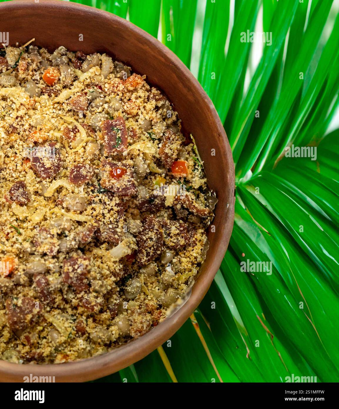 Traditional Brazilian farofa prepared with toasted cassava flour, bacon ...