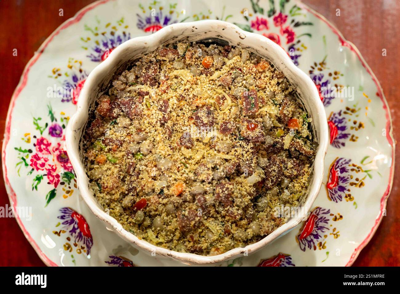Traditional Brazilian farofa prepared with toasted cassava flour, bacon ...