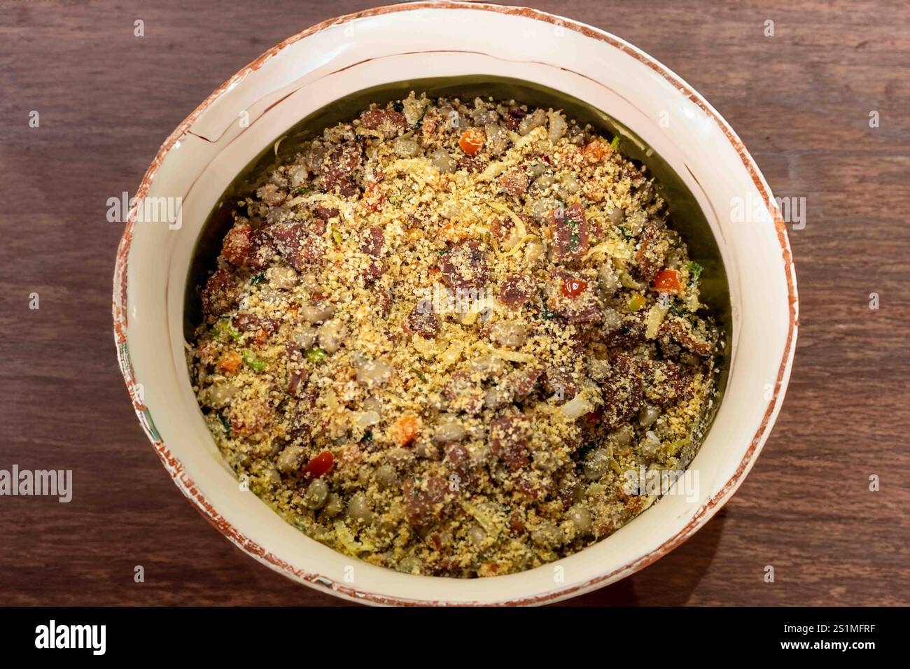 Traditional Brazilian farofa prepared with toasted cassava flour, bacon ...