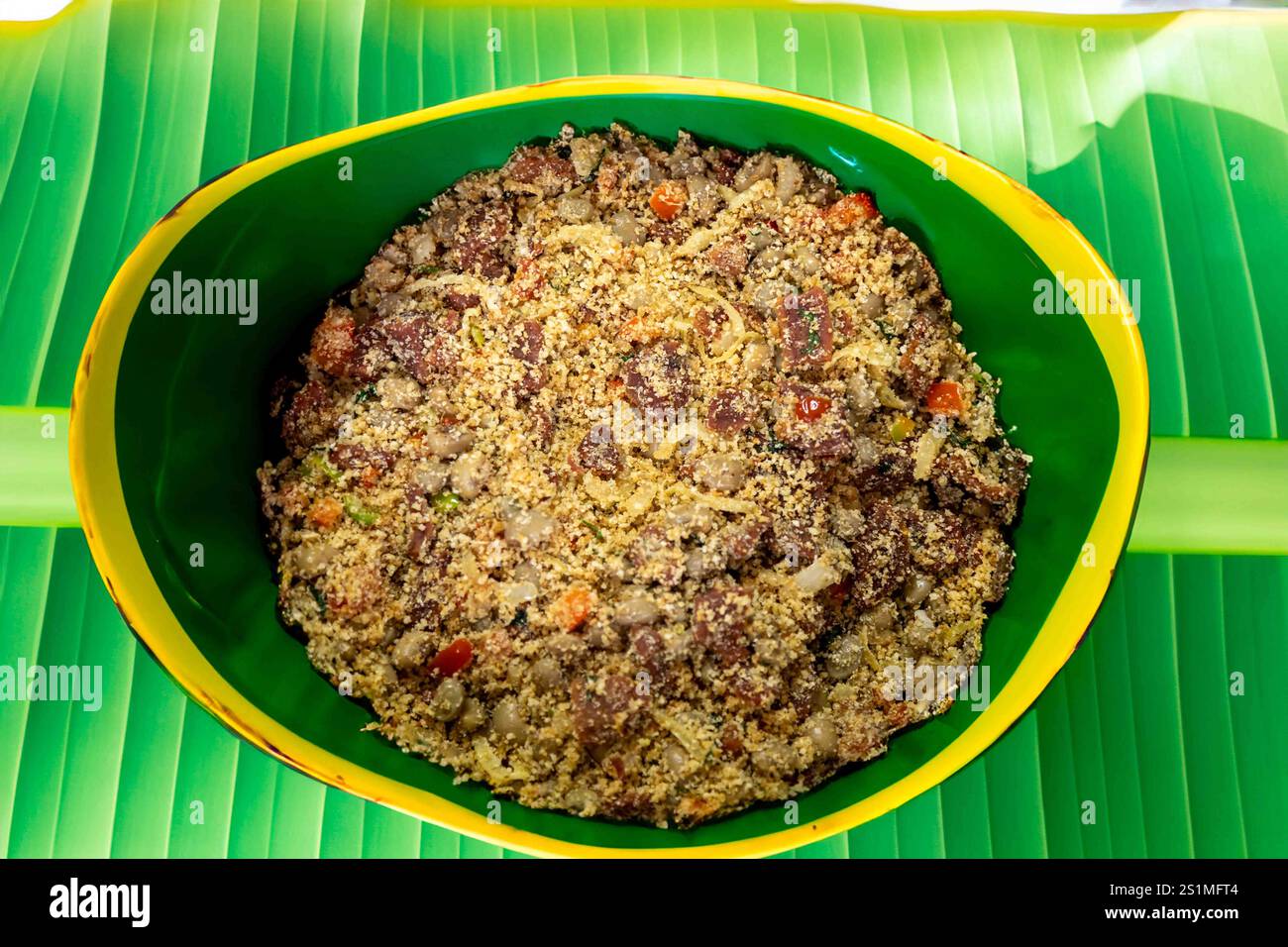 Traditional Brazilian farofa prepared with toasted cassava flour, bacon ...