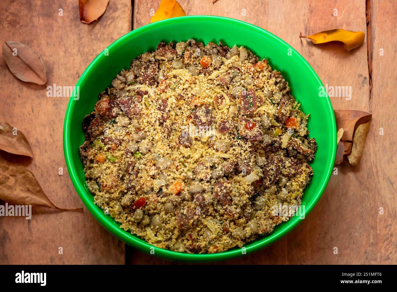 Traditional Brazilian farofa prepared with toasted cassava flour, bacon ...