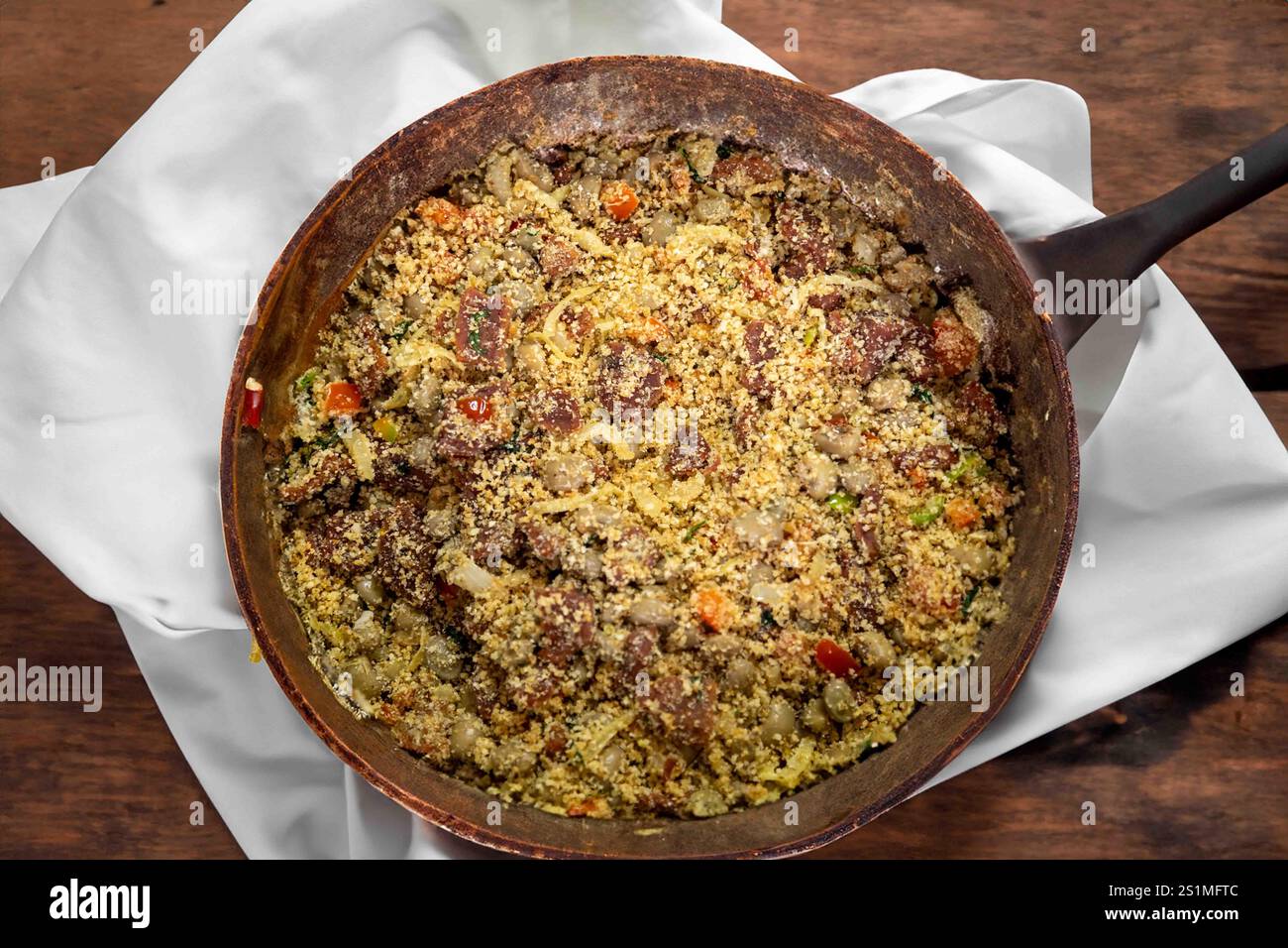 Traditional Brazilian farofa prepared with toasted cassava flour, bacon ...