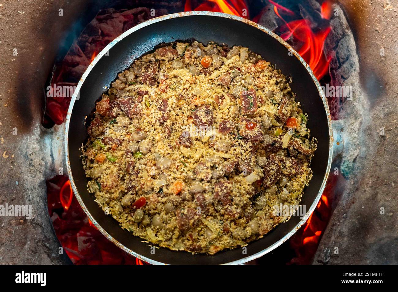 Traditional Brazilian farofa prepared with toasted cassava flour, bacon ...