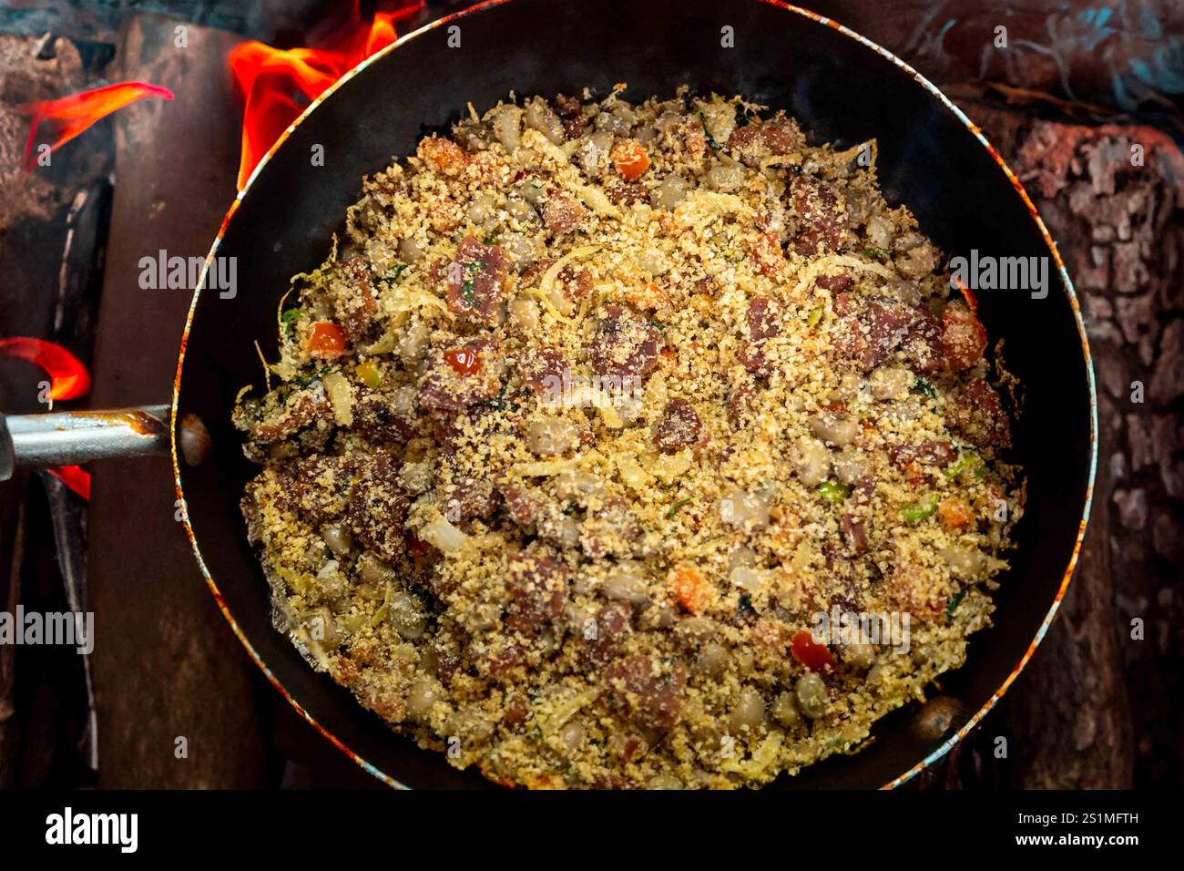 Traditional Brazilian farofa prepared with toasted cassava flour, bacon ...