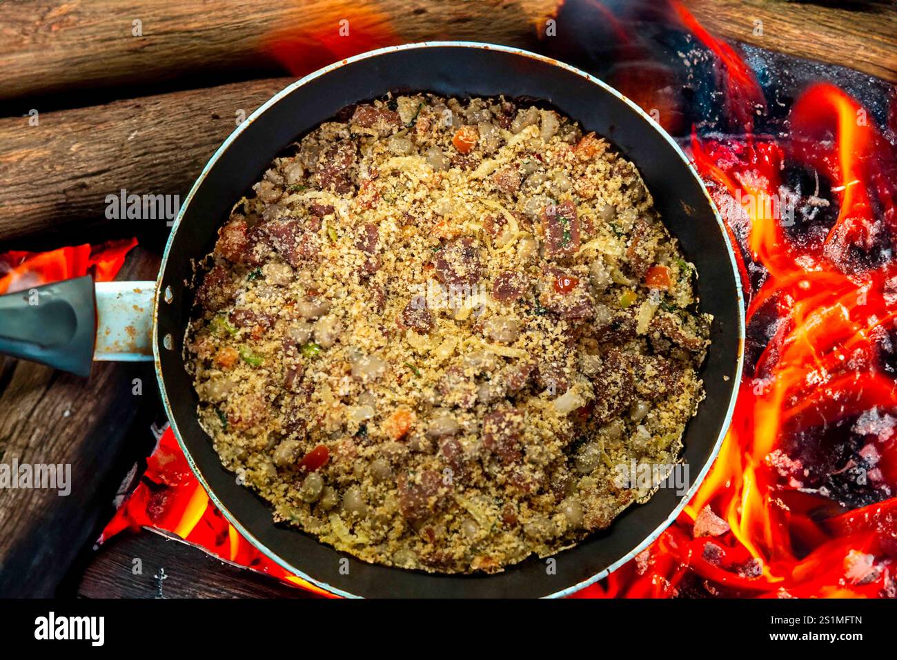 Traditional Brazilian farofa prepared with toasted cassava flour, bacon ...