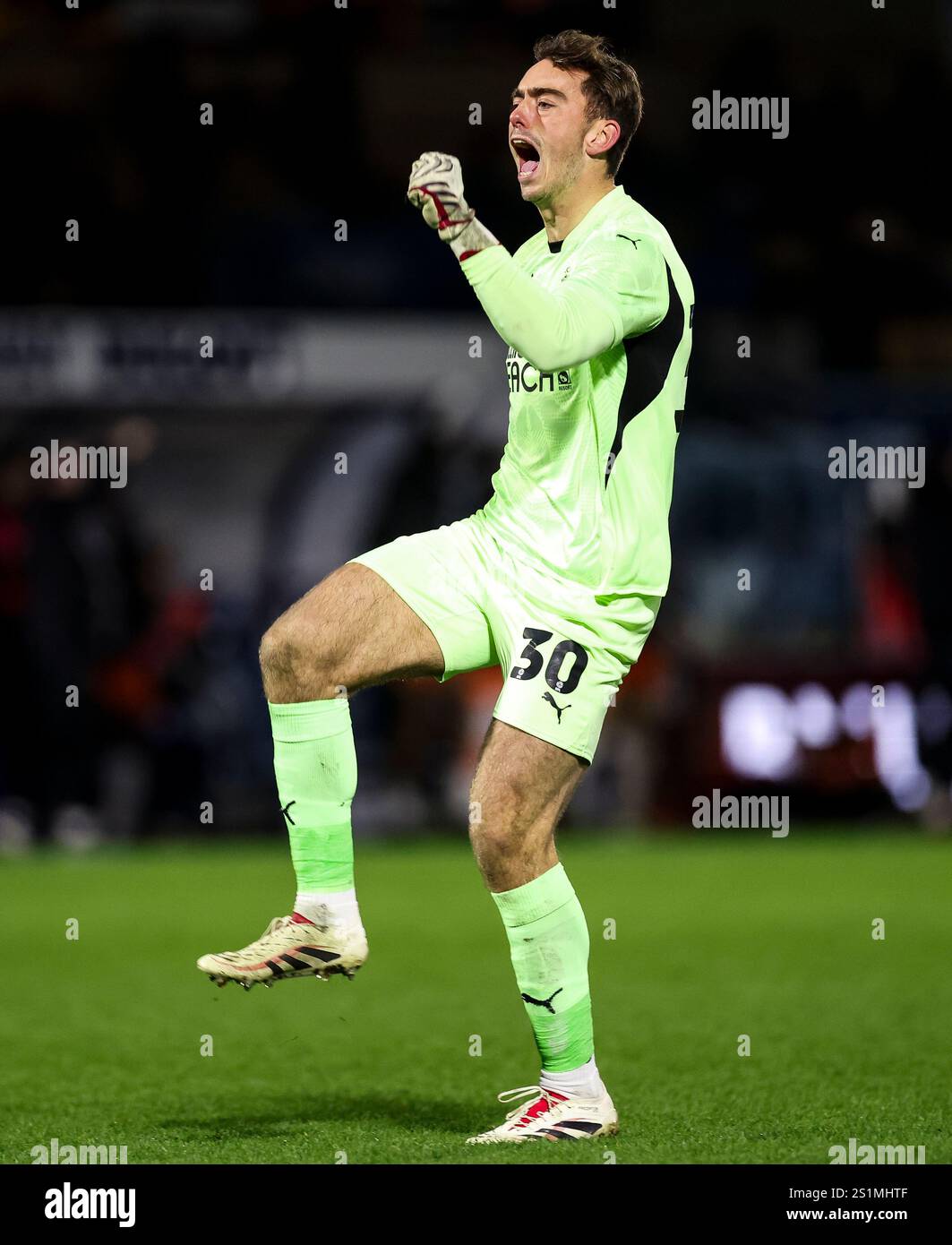 Blackpool's goalkeeper Harry Tyrer celebrating as Kyle Joseph (not ...
