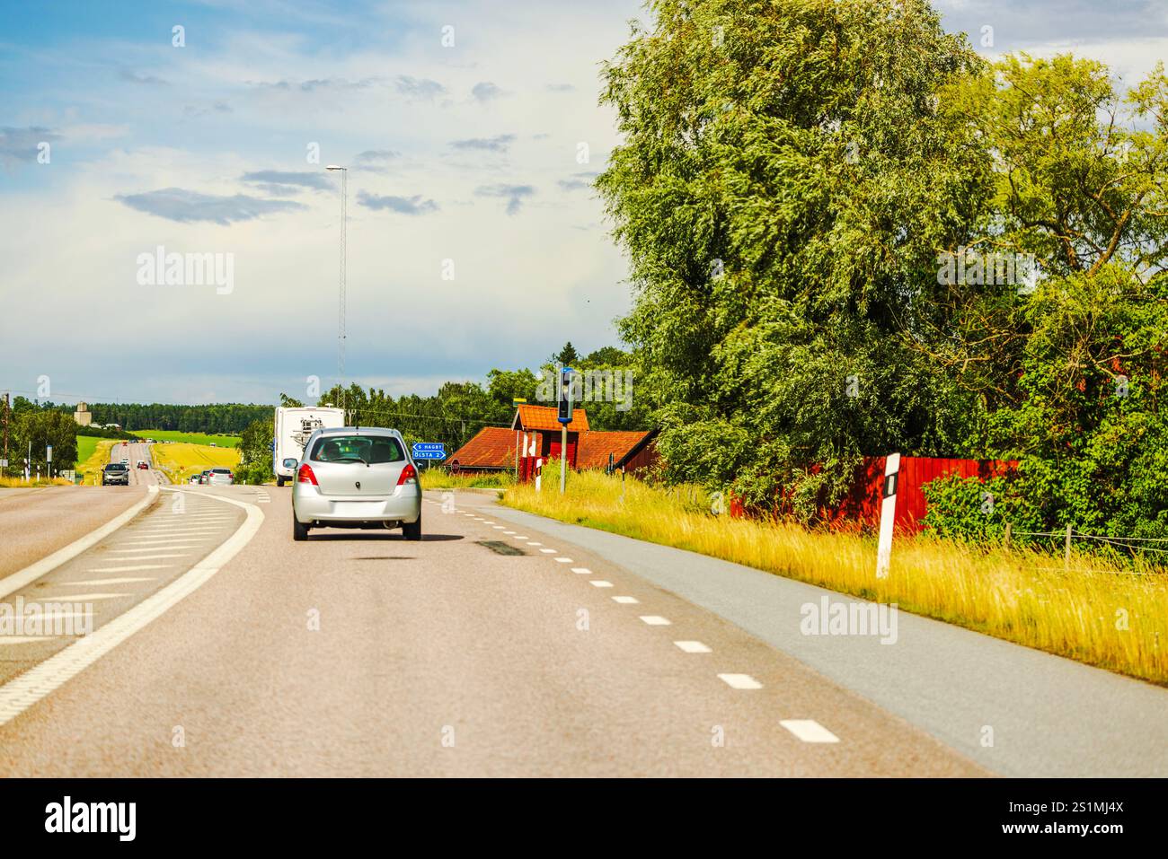 Speed camera monitoring traffic on countryside road with cars driving ...