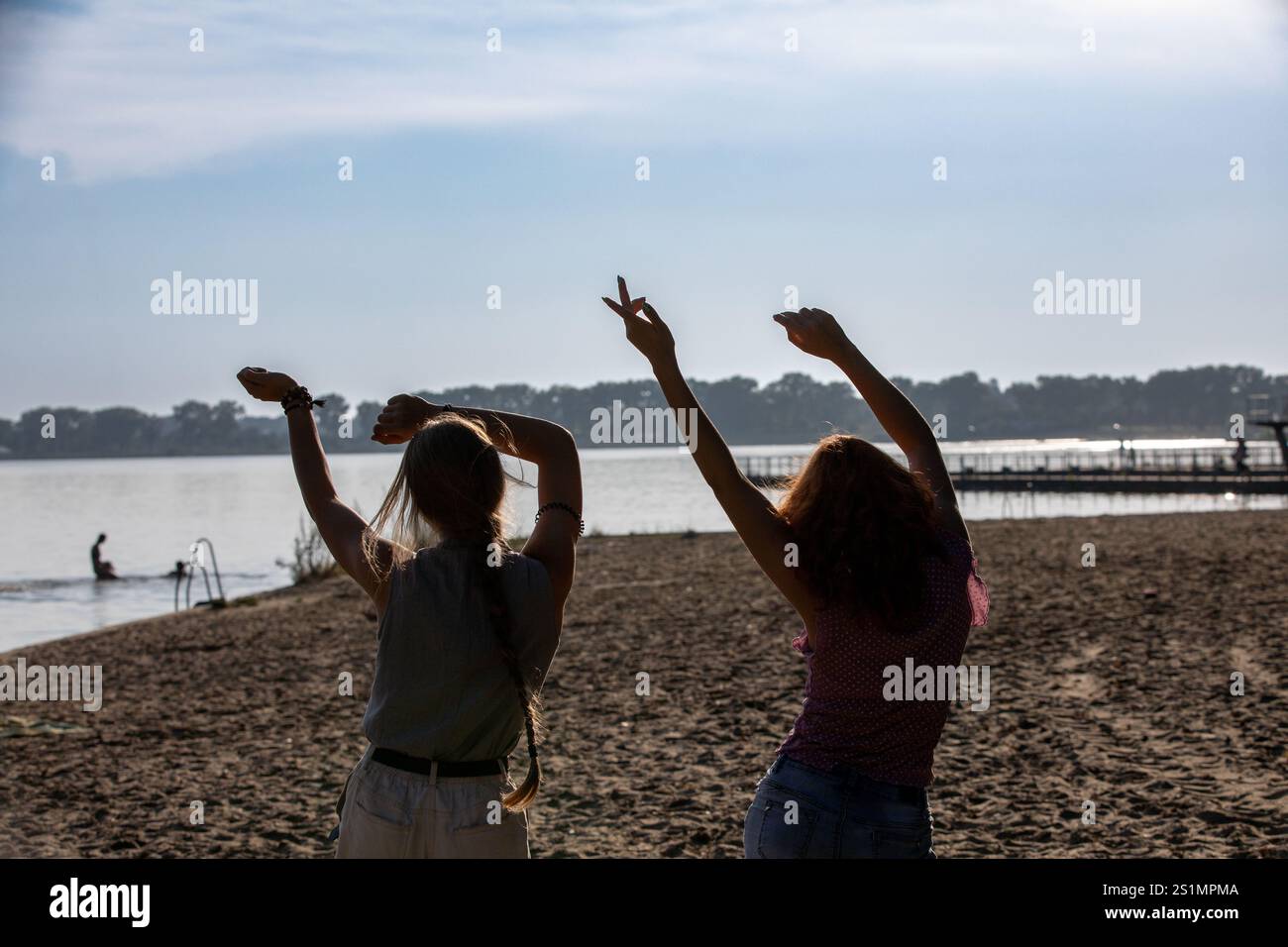 Two friends joyfully celebrating life with lively movements on the ...