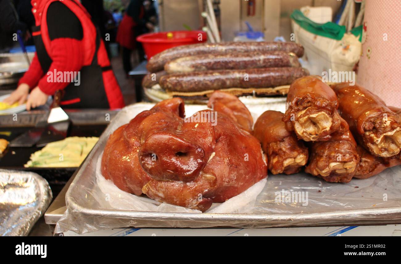 Pig head and leg on a butcher's shelves in Gwangjang Market, Seoul ...