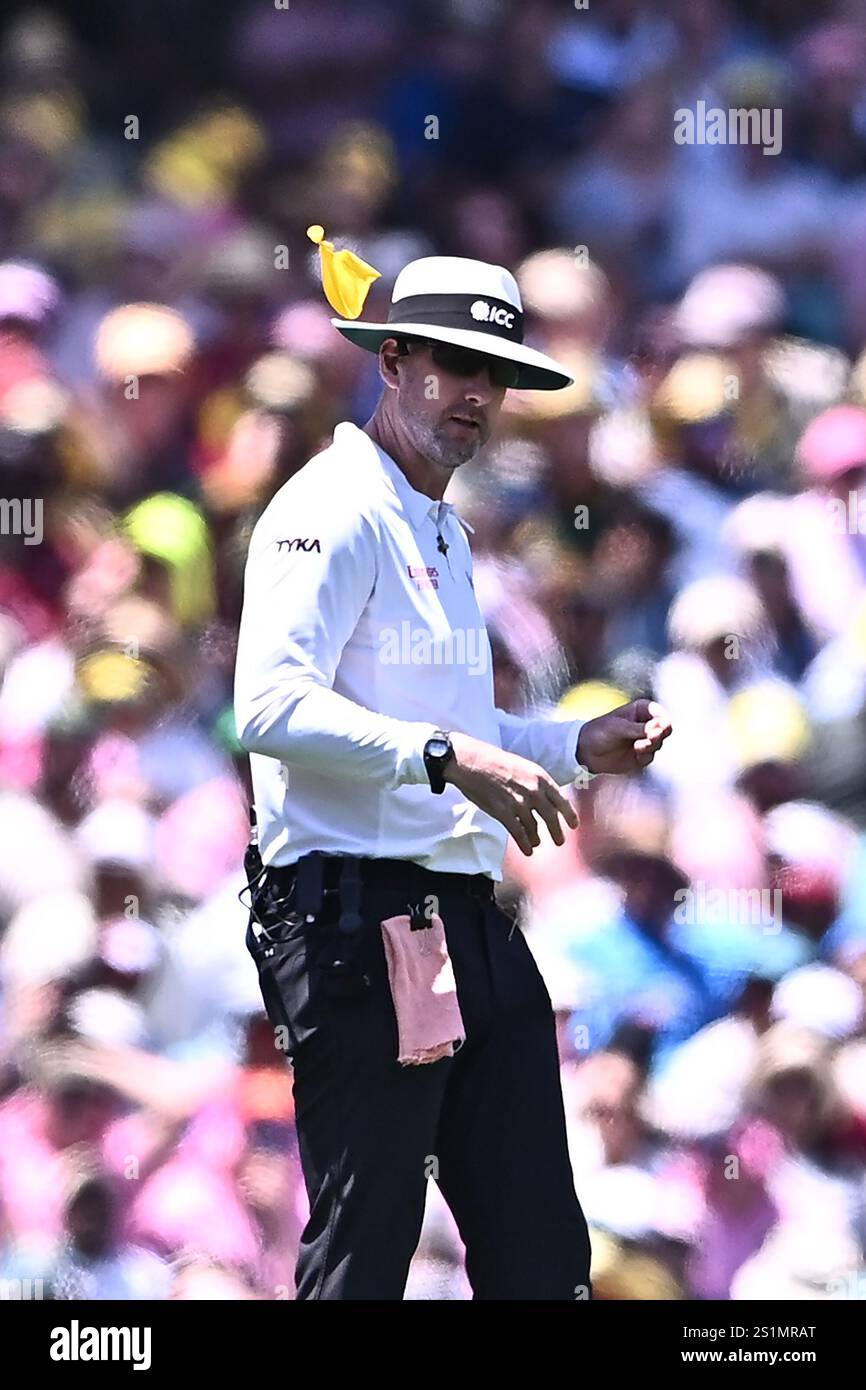 Umpire Michael Gough deflates a balloon which came on the field during ...