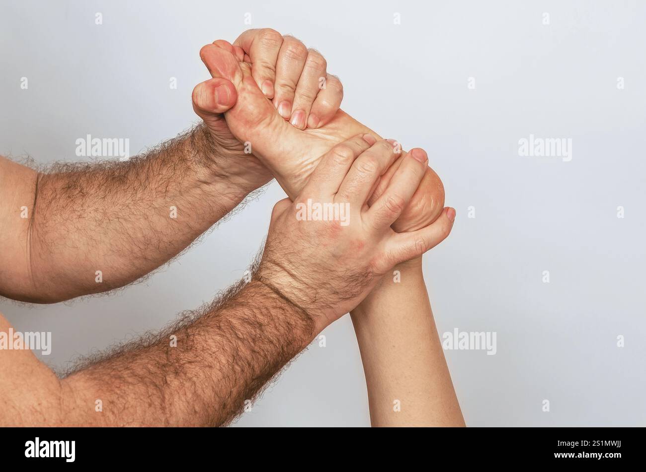Detail of finger pressure on foot, reflexology. Woman receiving foot ...