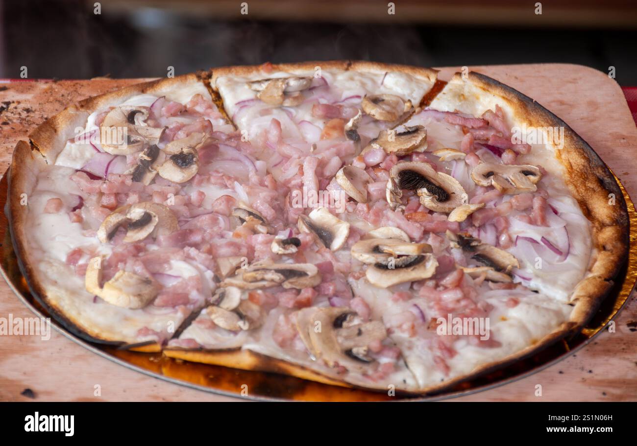 Traditional food of Alsace, flammekuche wood oven baked tarte with ...