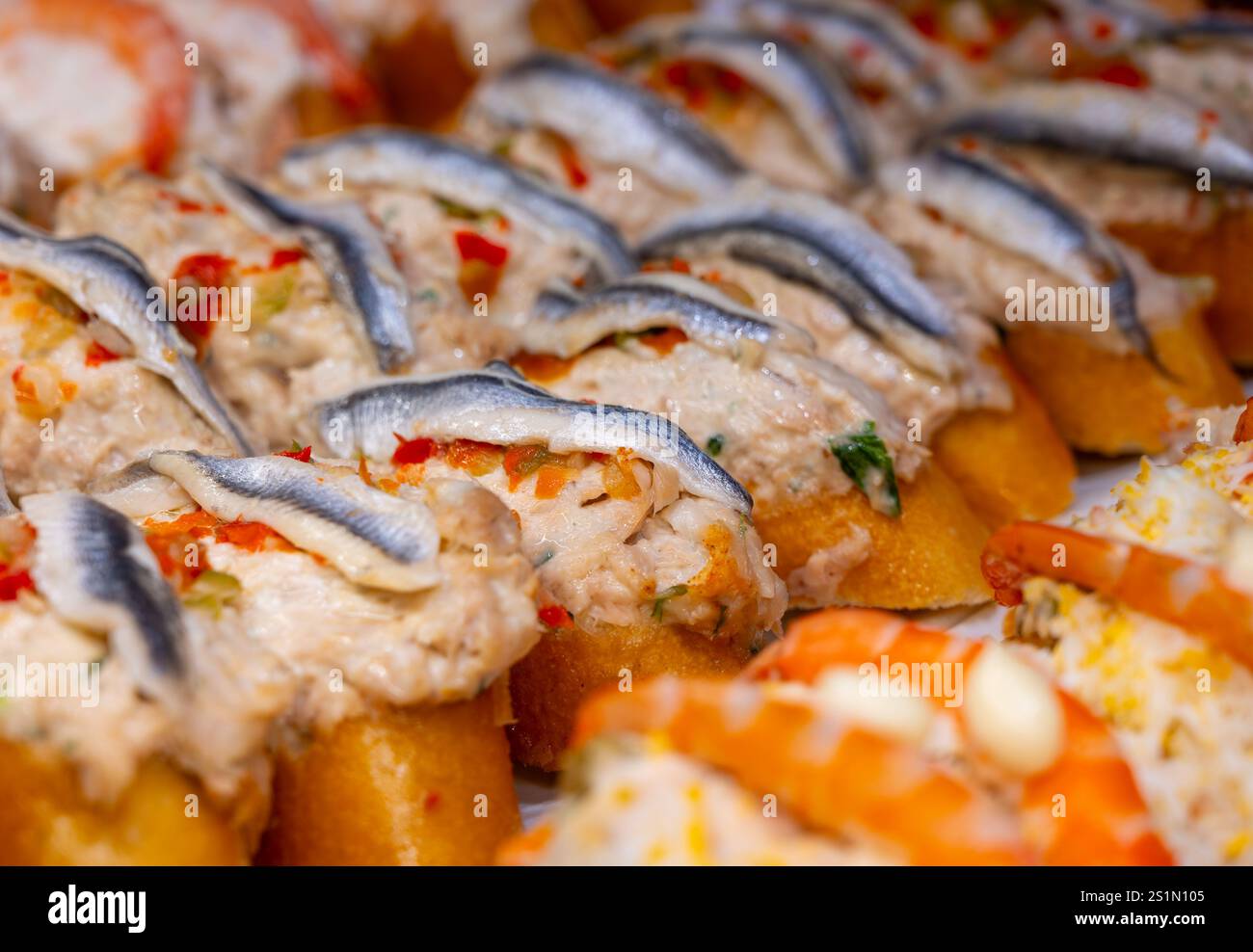 Typical snack of Basque Country, pinchos or pinxtos skewers with small ...