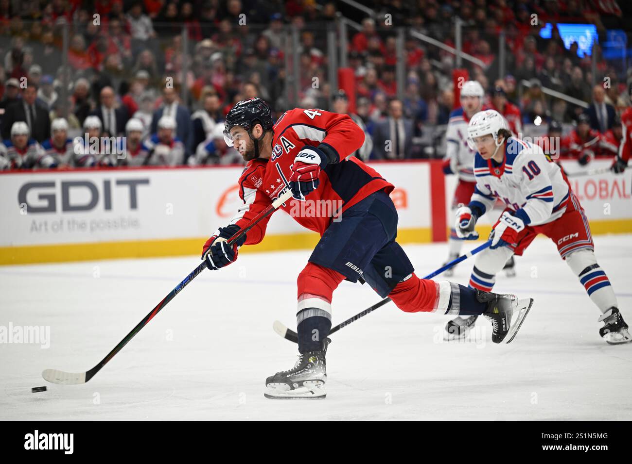 Washington Capitals right wing Tom Wilson, left, takes a shot as New ...