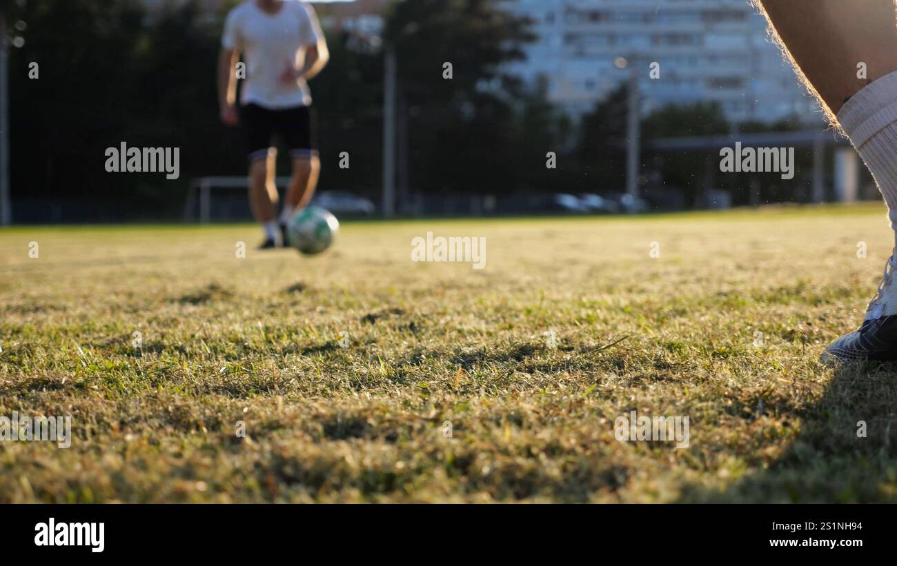 Male feet of professional footballers passing soccer ball on stadium at ...