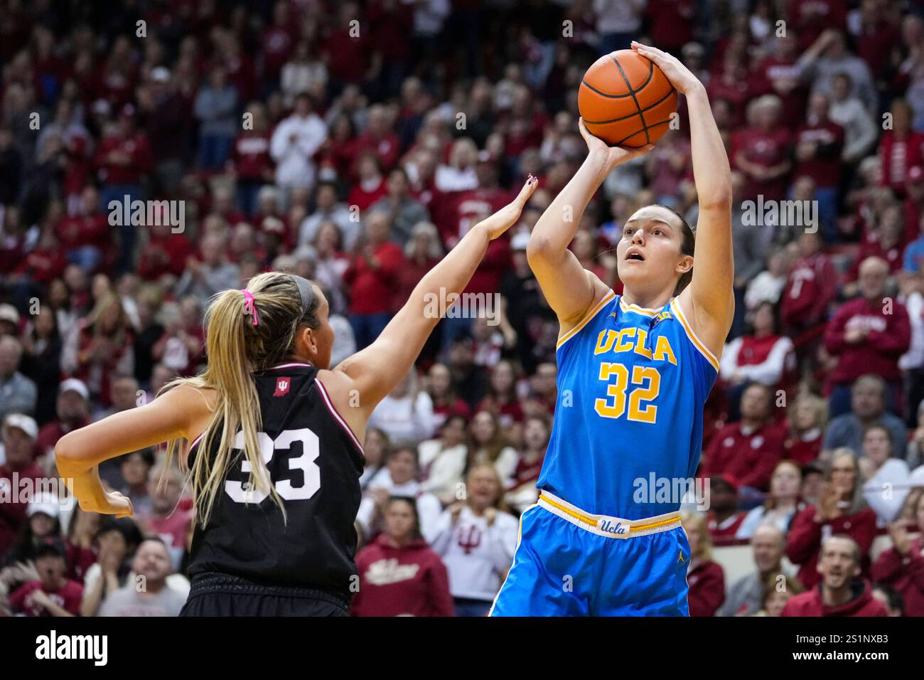 UCLA forward Angela Dugalic (32) shoots over Indiana guard Sydney Parrish (33) in the second ...