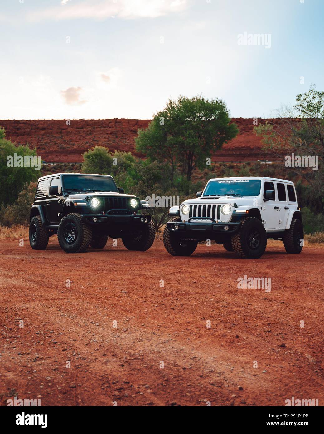 Two rugged Jeep Wranglers side by side on a red dirt trail, ready for ...