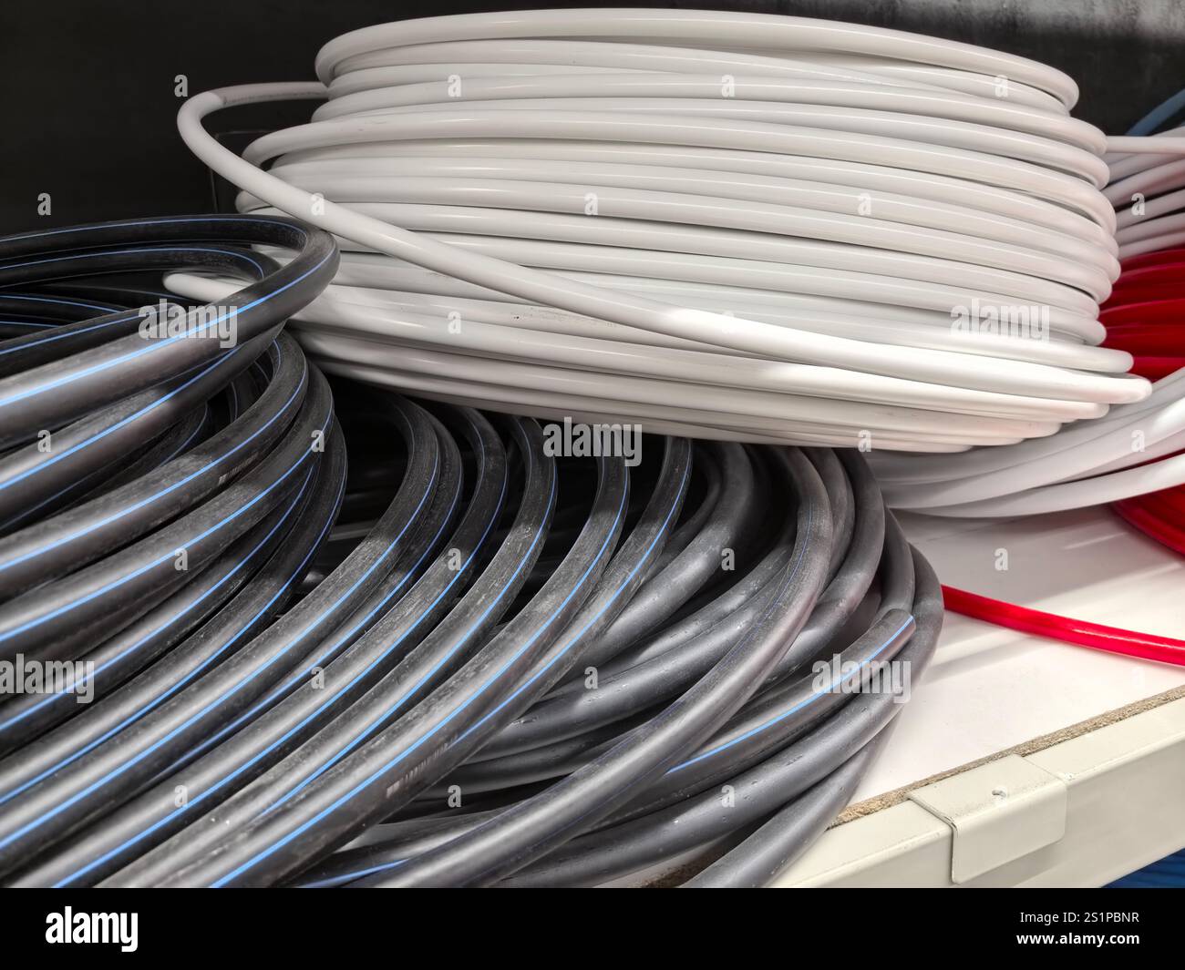Various coiled wires in black, white, and red are organized in a ...