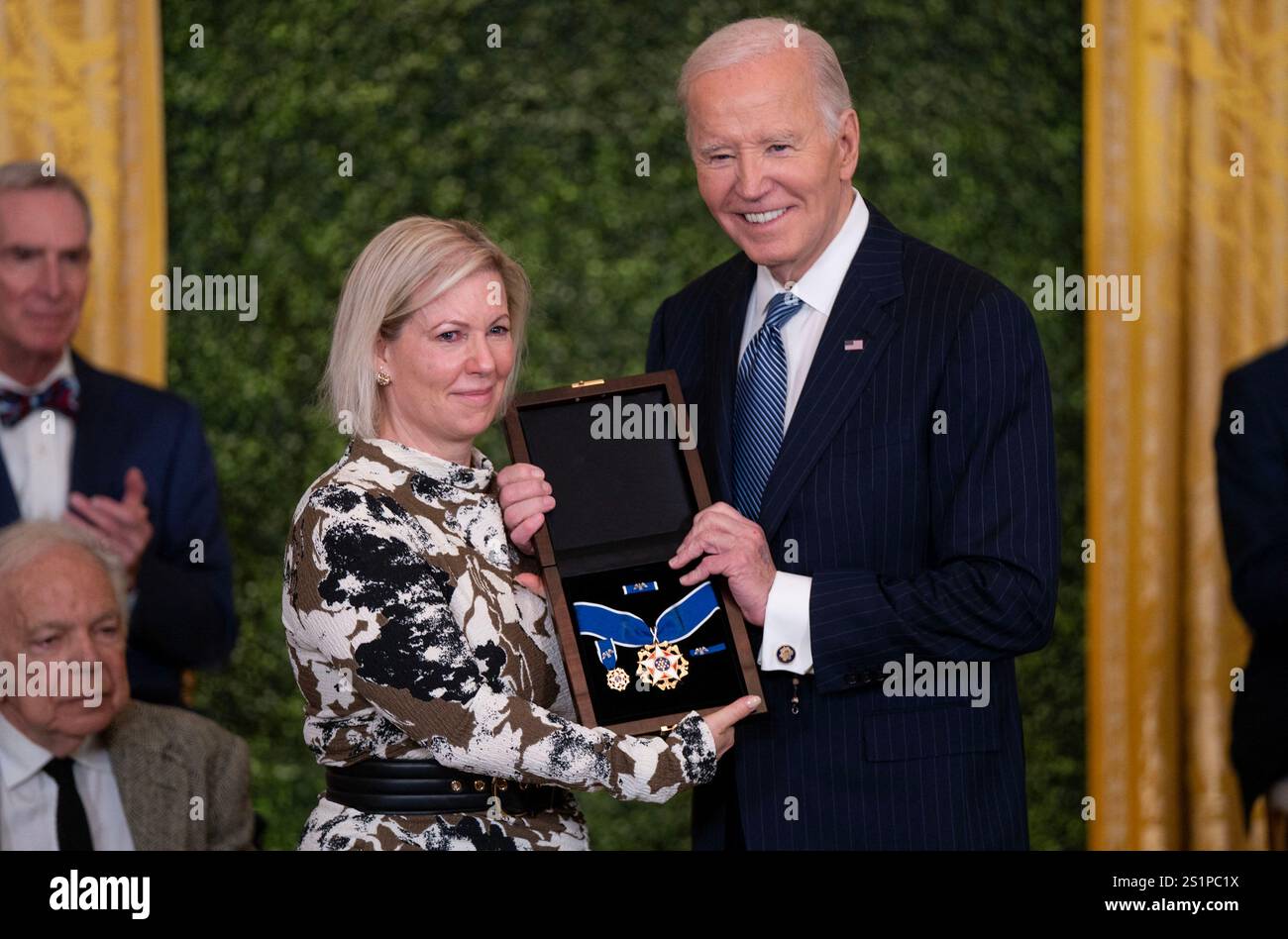 President Joe Biden presents Stephanie Carter, wife of former Secretary ...