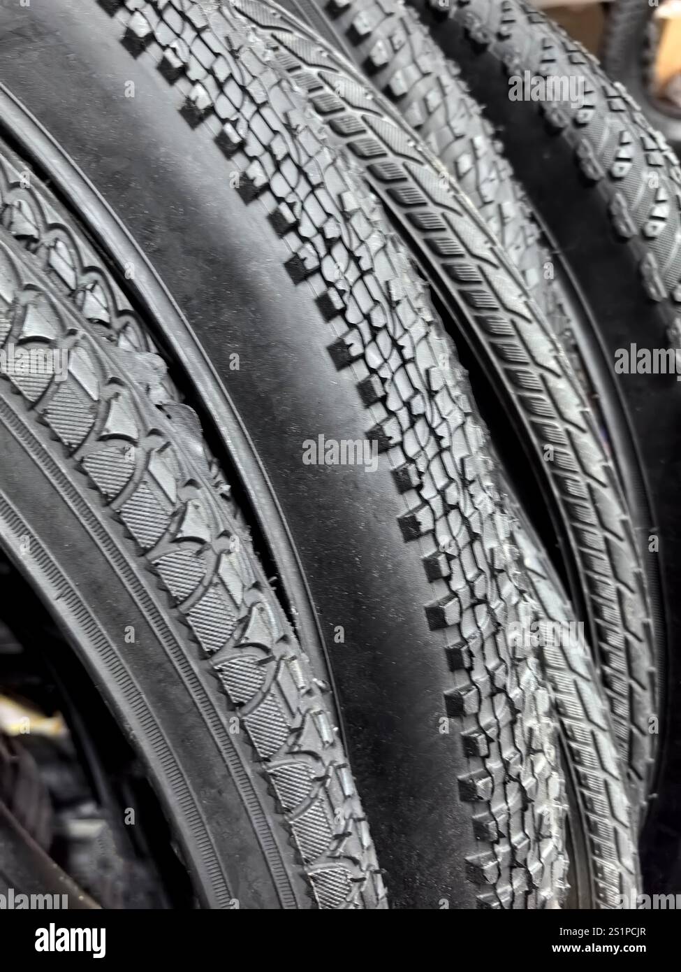 A close-up view captures the intricate patterns of tire treads stacked ...
