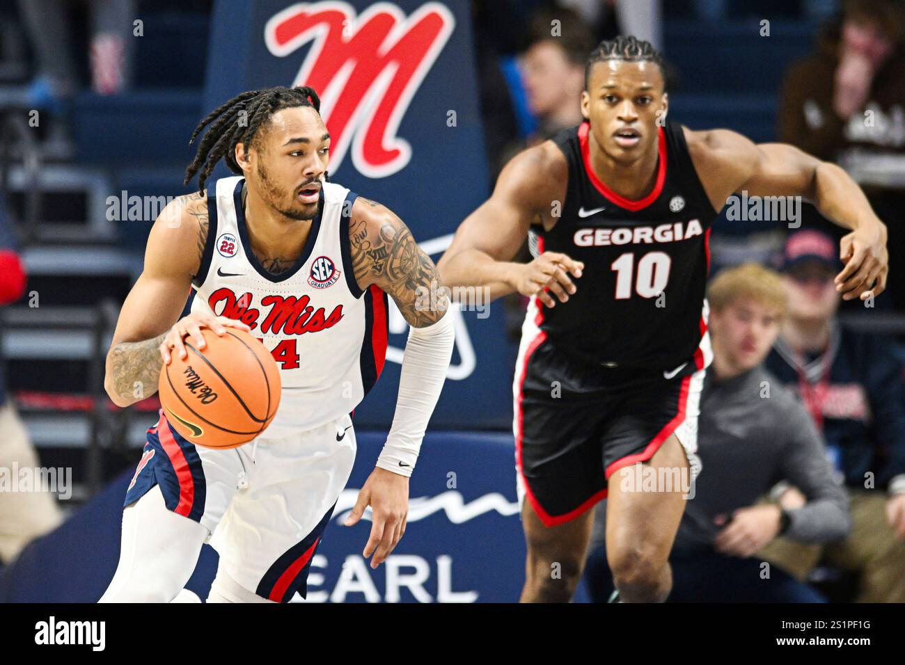 Mississippi guard Dre Davis (14) dribbles ahead of Georgia forward RJ ...