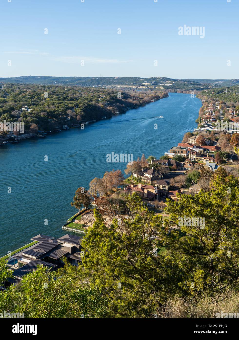 Expensive waterfront homes line the Colorado river near Austin Texas ...
