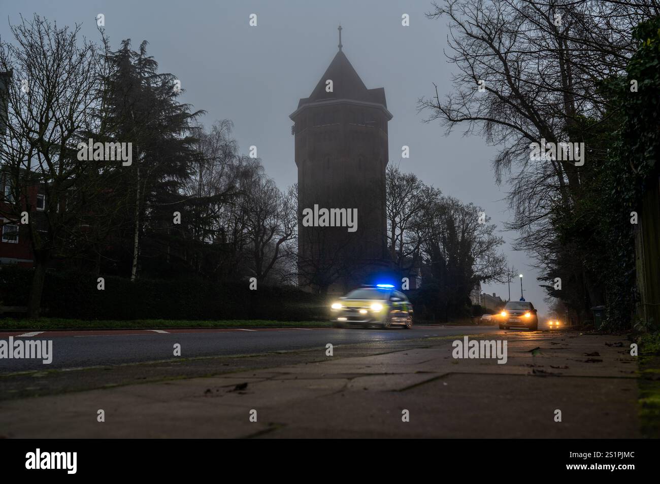 Police car with blue lights overtaking traffic by the Shooter's Hill ...