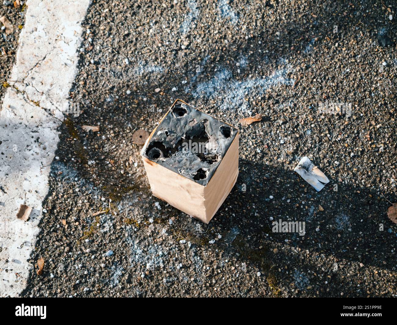 Close-up of charred firework remains on the asphalt in Strasbourg's ...