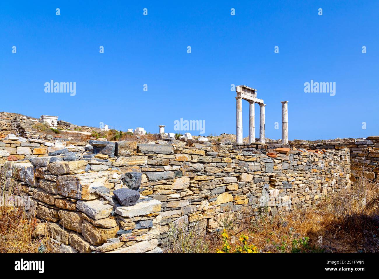Ancient Stone Ruins with Pillars Against Clear Blue Sky, Delos, Greece ...