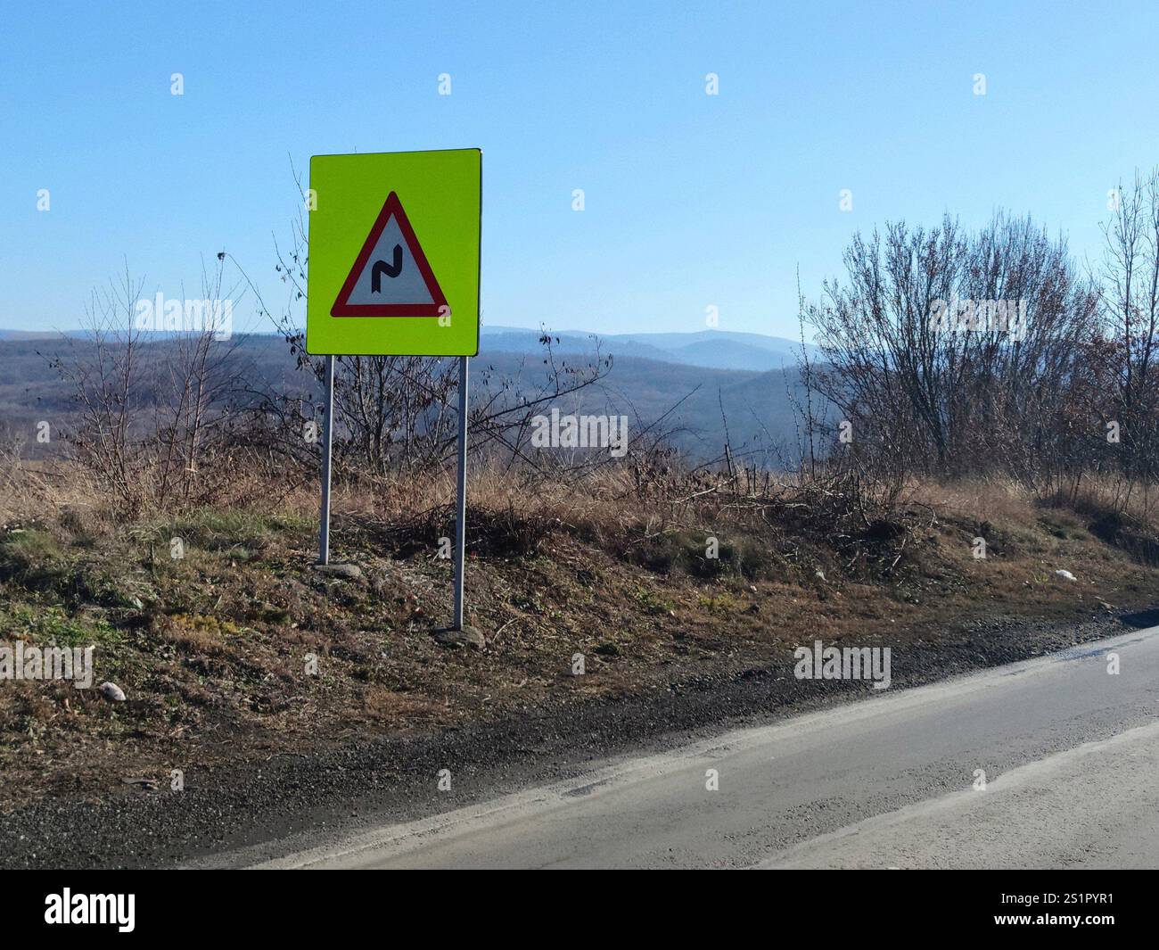 Road sign for a winding road in the mountains of Transylvania, west of ...