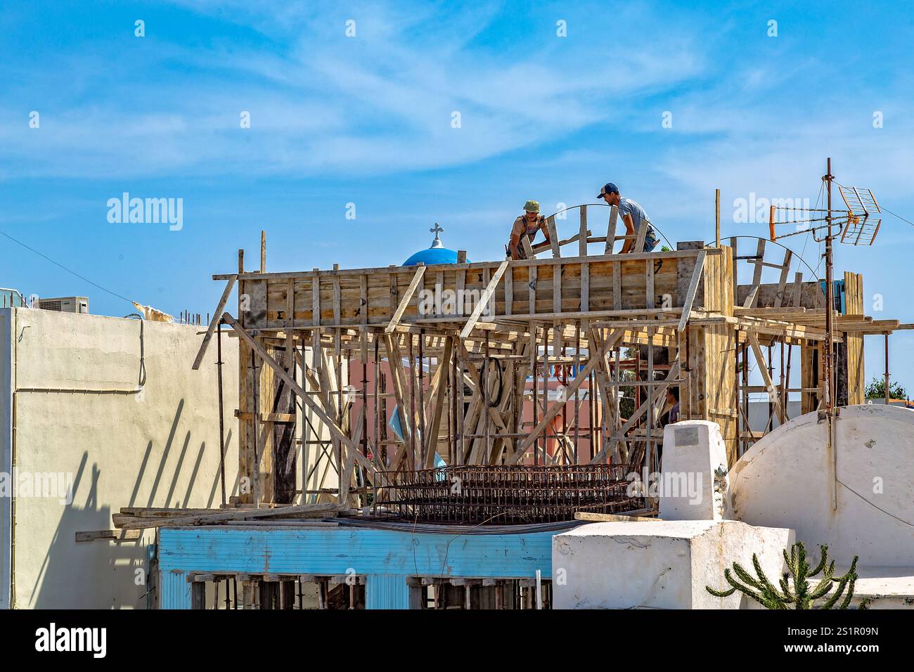 Construction Workers Building A Wooden Framework On Top Of A Roof, Oia ...