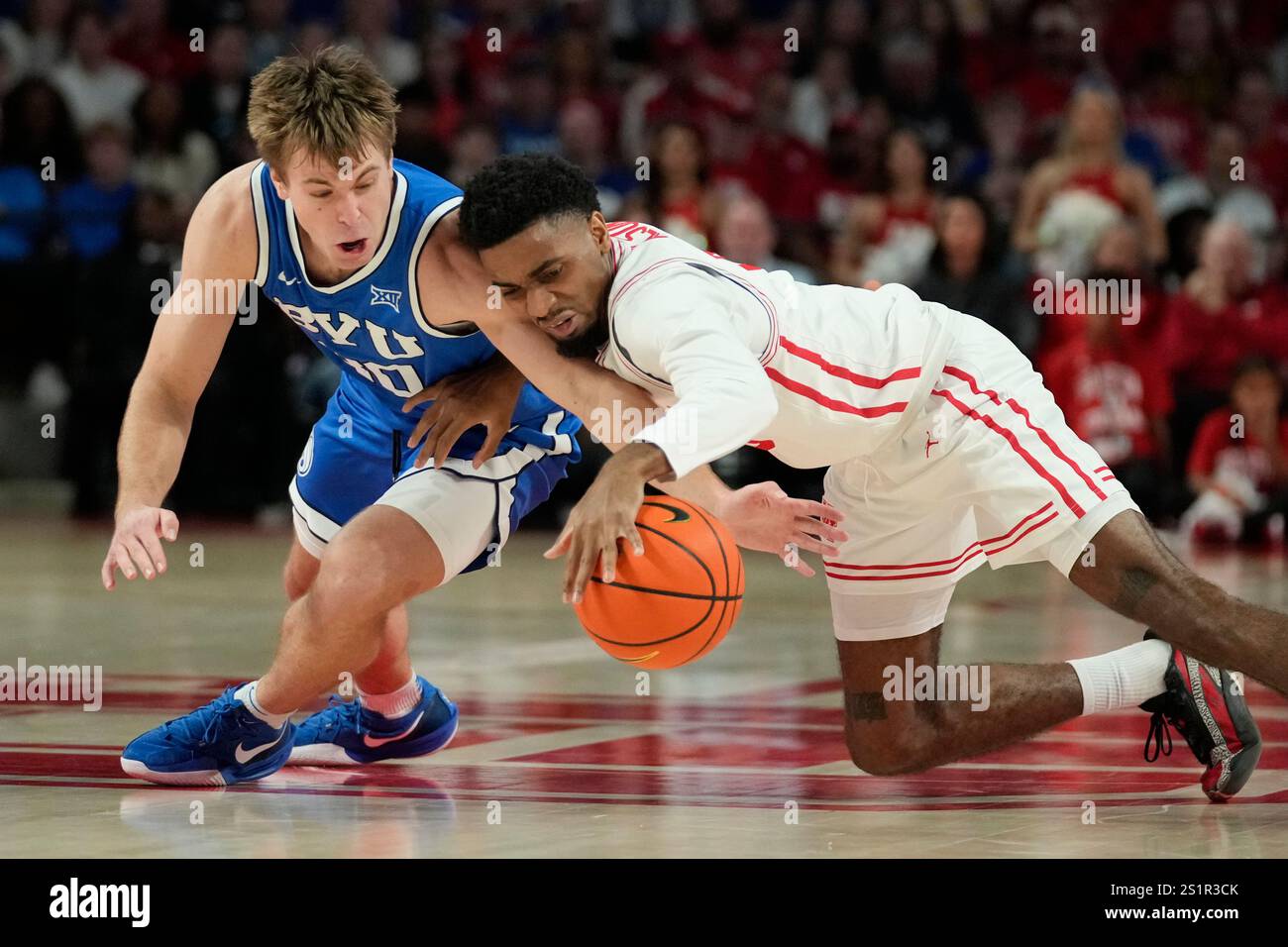 BYU guard Dallin Hall, left, and Houston guard Mylik Wilson dive for a ...
