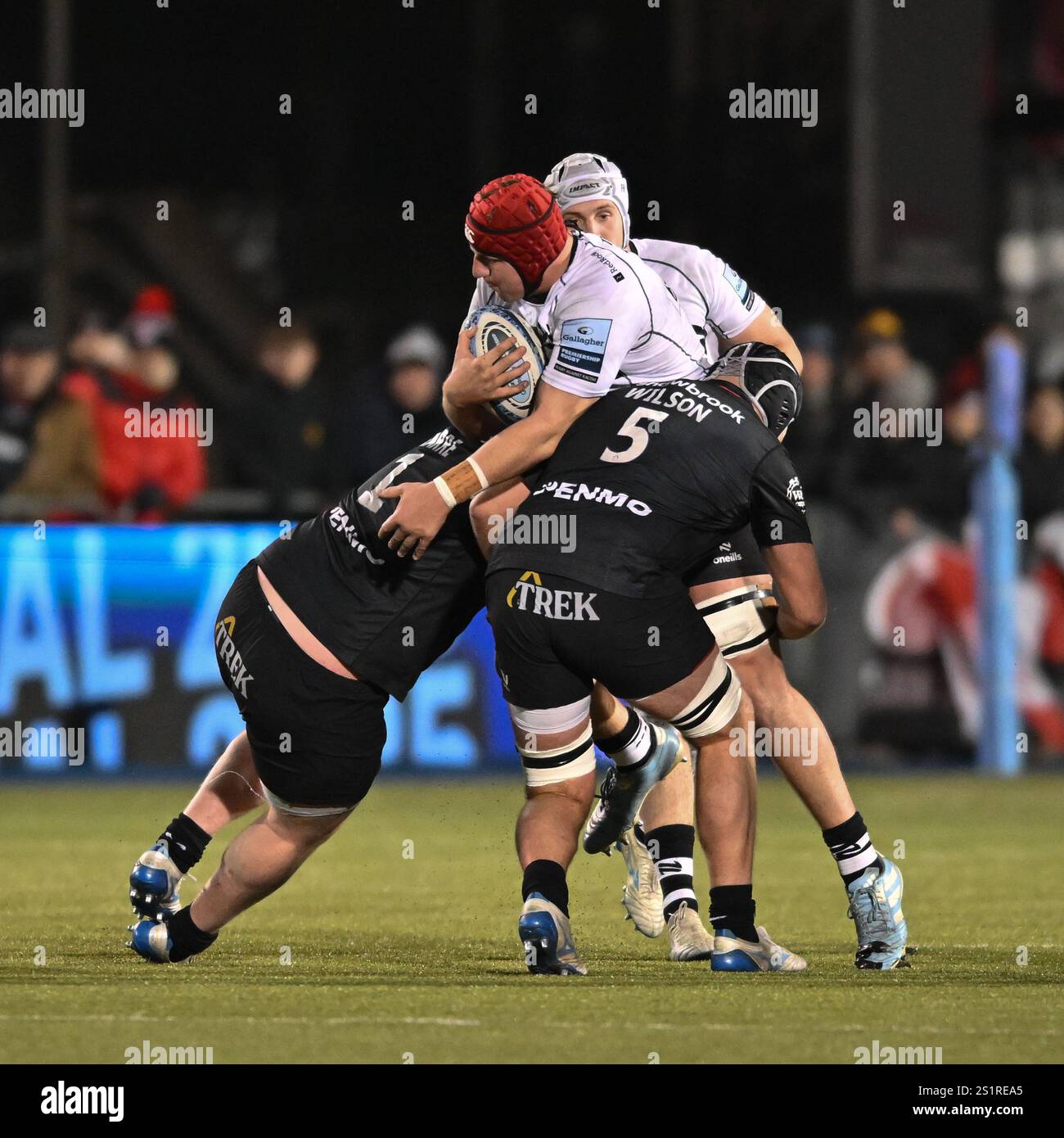 Harry Wilson and Rhys Carre of Saracens tackles James Dun of Bristol ...