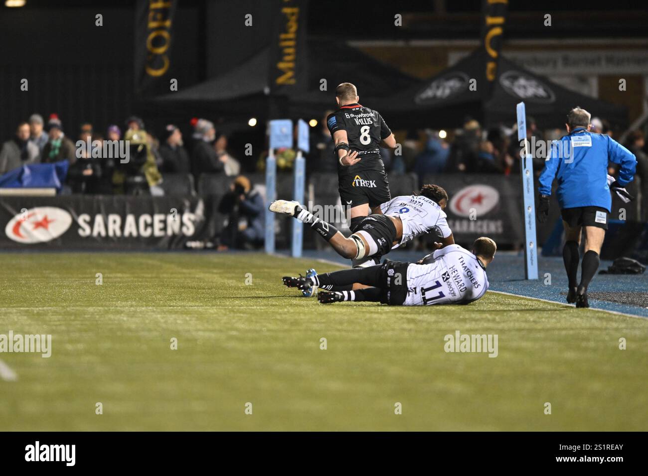 Tom Willis of Saracens side steps the tackle by Noah Heward and Vilame ...