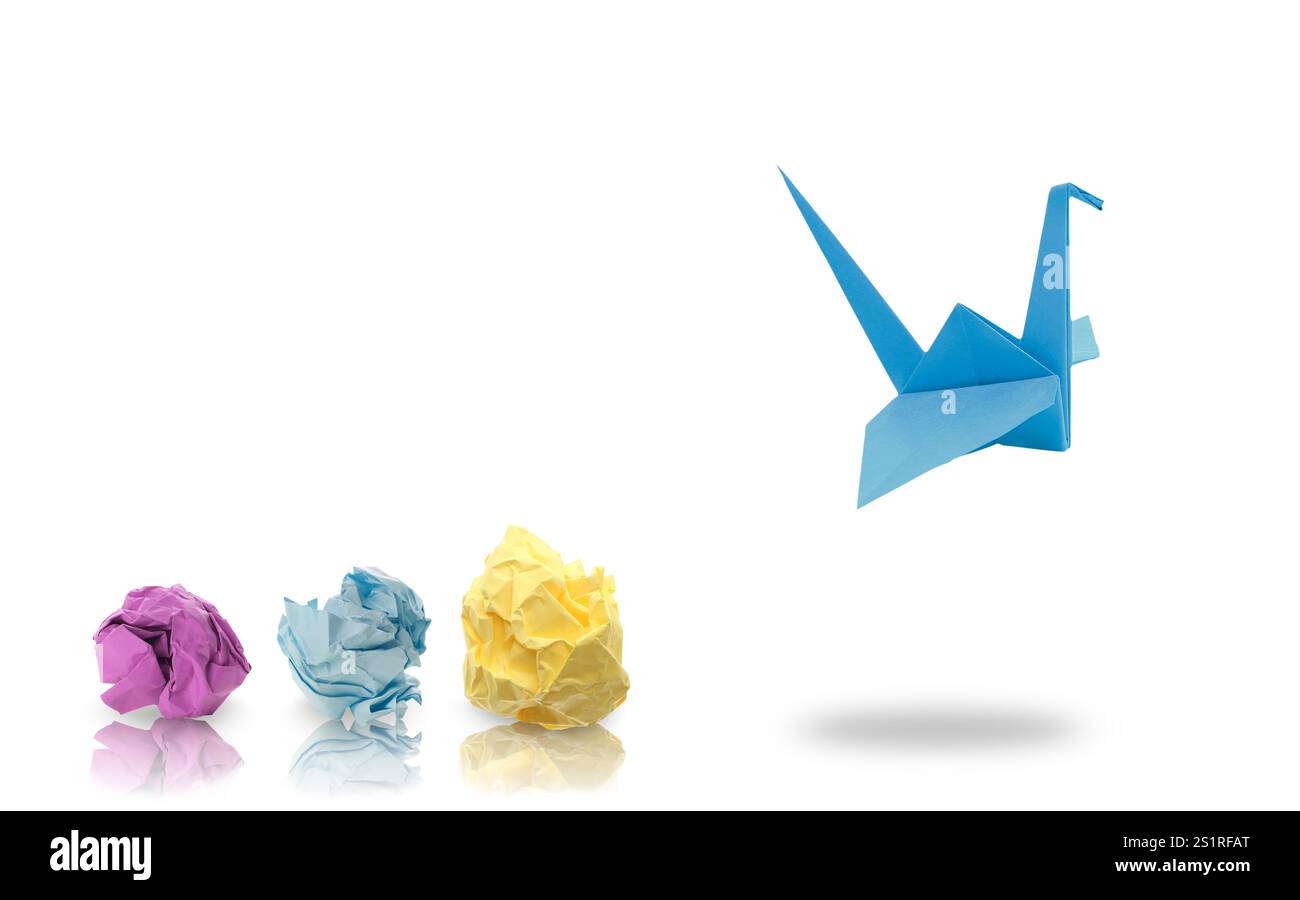 Blue origami crane and crumpled paper balls on white background, banner ...