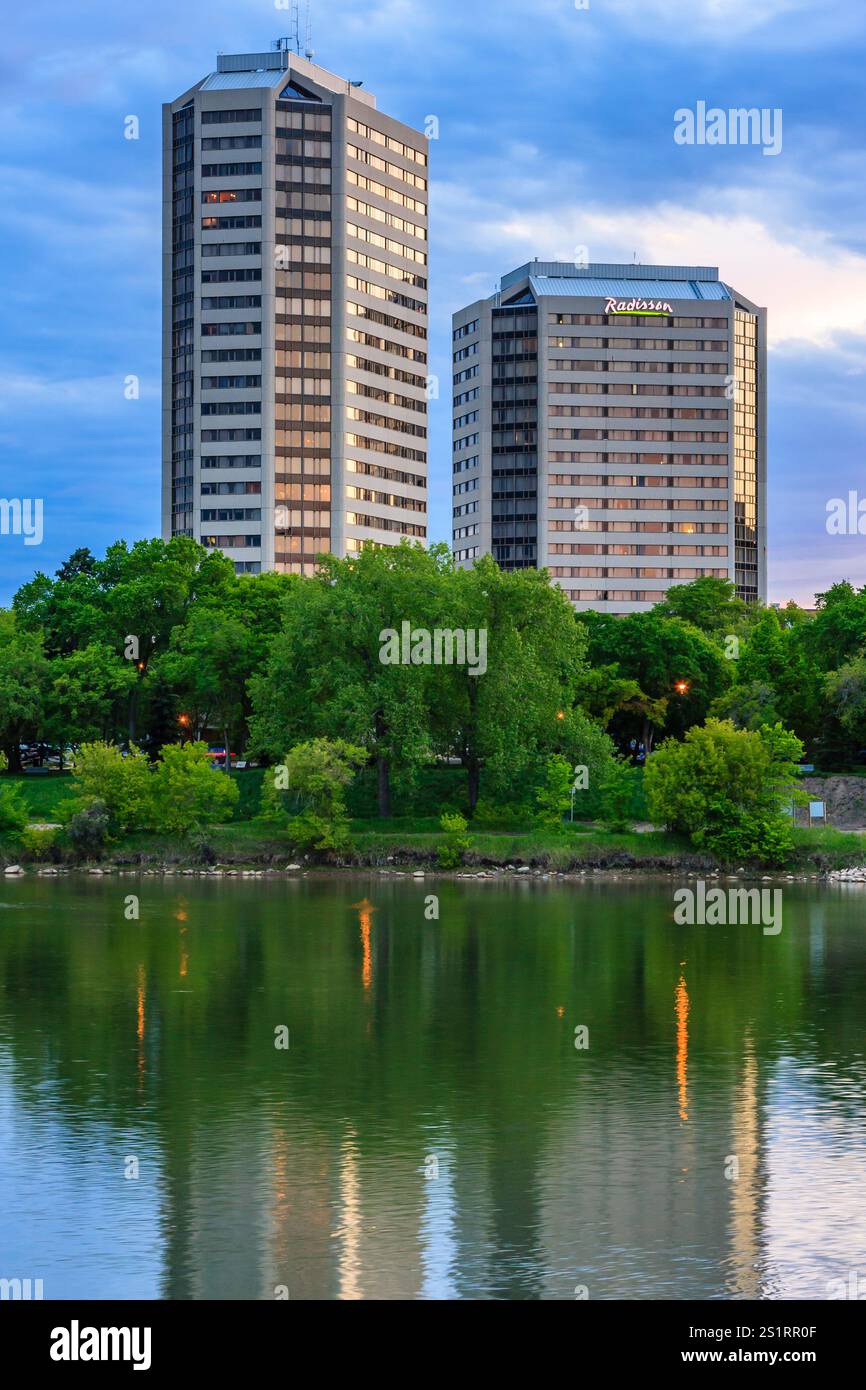 Two tall buildings with a large body of water in between them. The ...