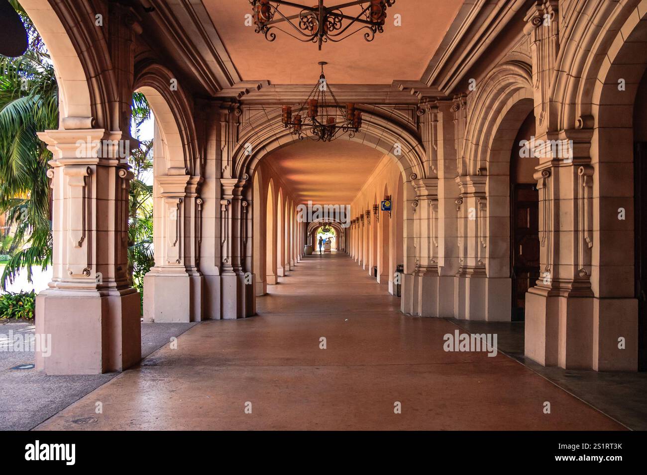 A long hallway with arched ceilings and a chandelier hanging from the ...