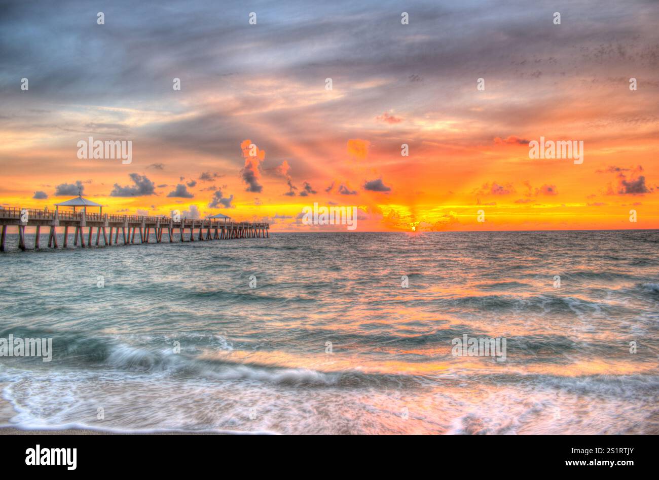 The Calm Before the Storm. Juno Beach Pier Florida Sunrise, Choppy Waves Stock Photo - Alamy