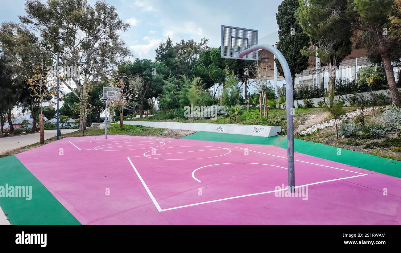 an outdoor basketball court in faro, portugal, with a unique pink floor ...