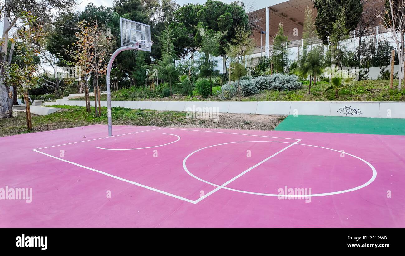 an outdoor basketball court in faro, portugal, with a unique pink floor ...