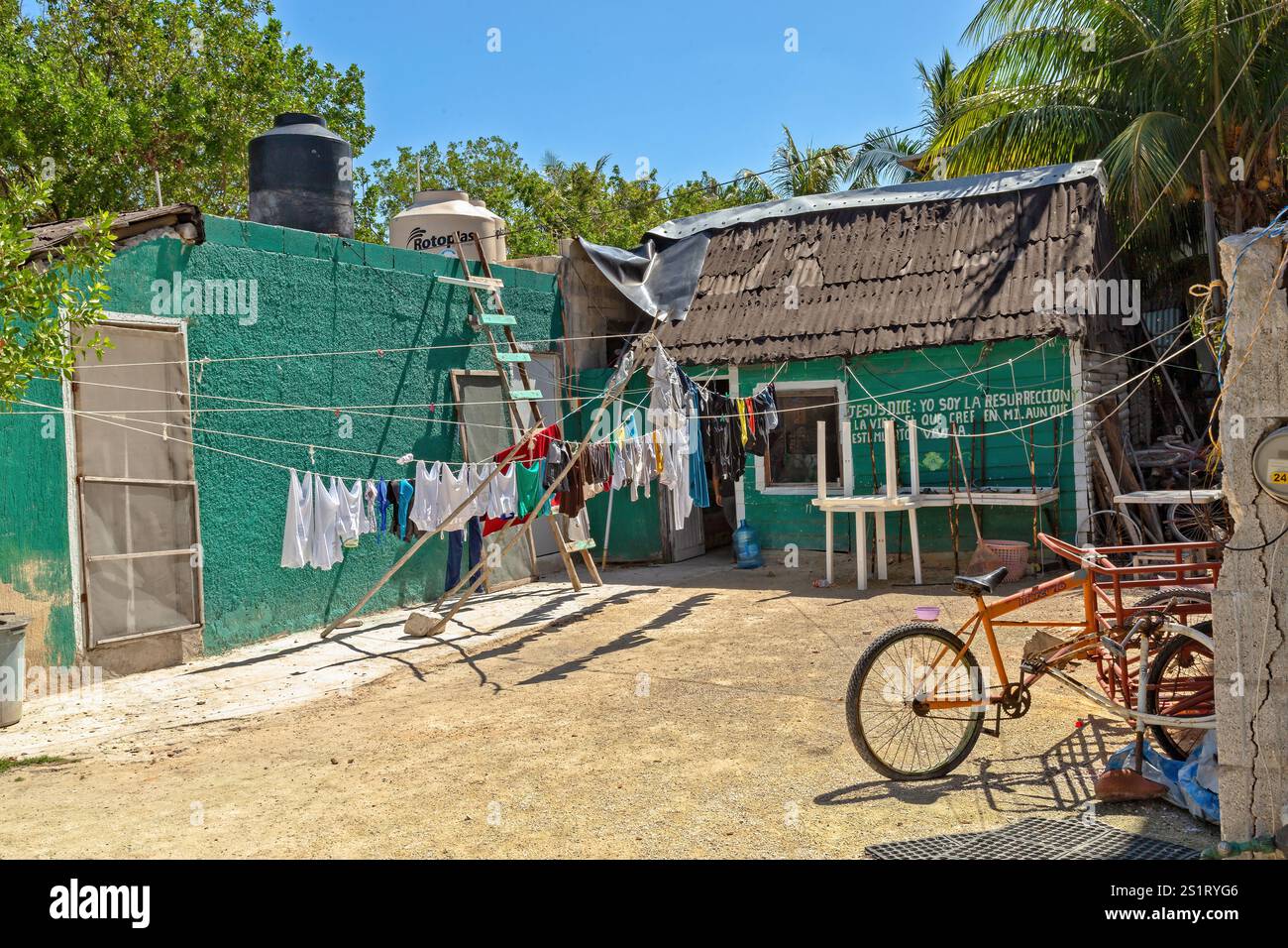Rustic Backyard With Laundry Lines, Bicycle, and Green Building, Isla ...
