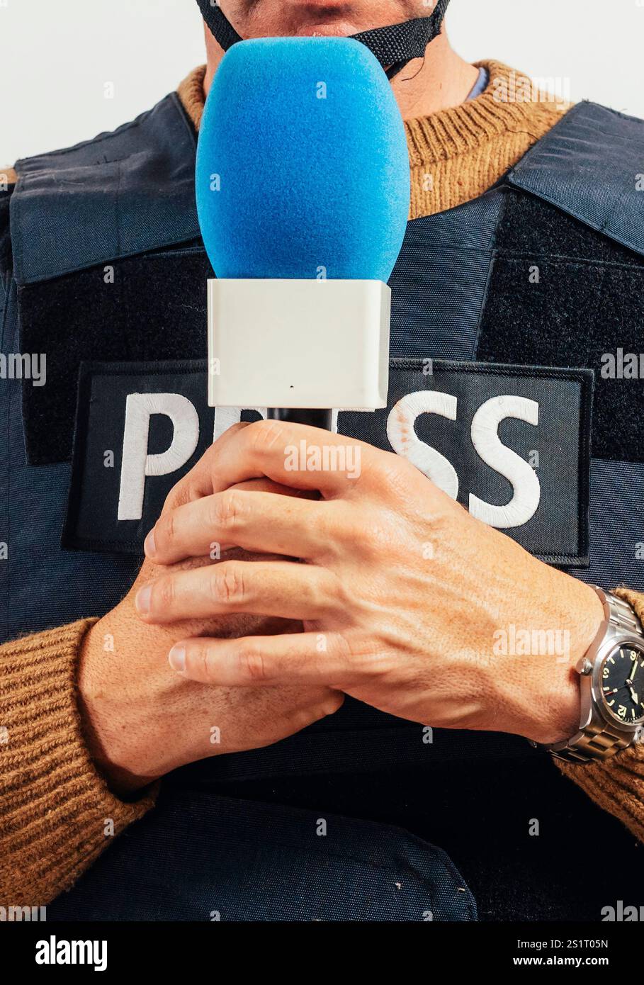 Reporter with bulletproof vest holding a microphone in studio Stock ...