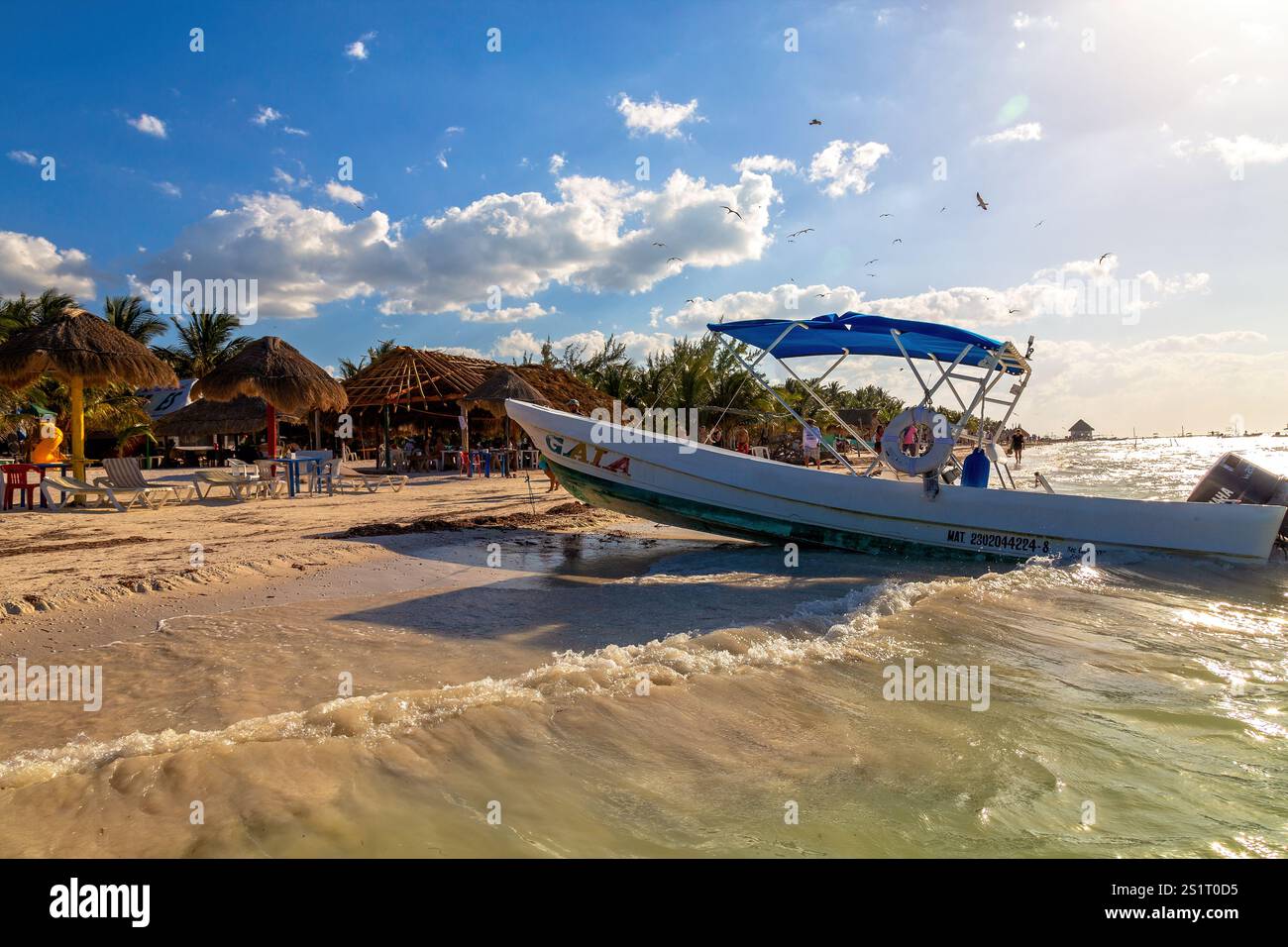 Seaside Fishing Boat at Sunset with Tropical Beach Huts and Vibrant Sky ...