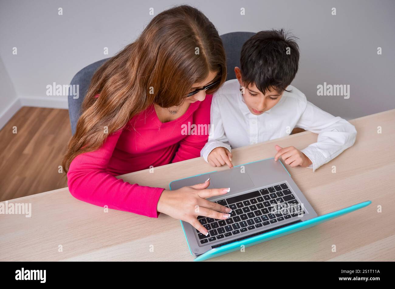 Teacher and student using laptop in a classroom, focusing on education ...