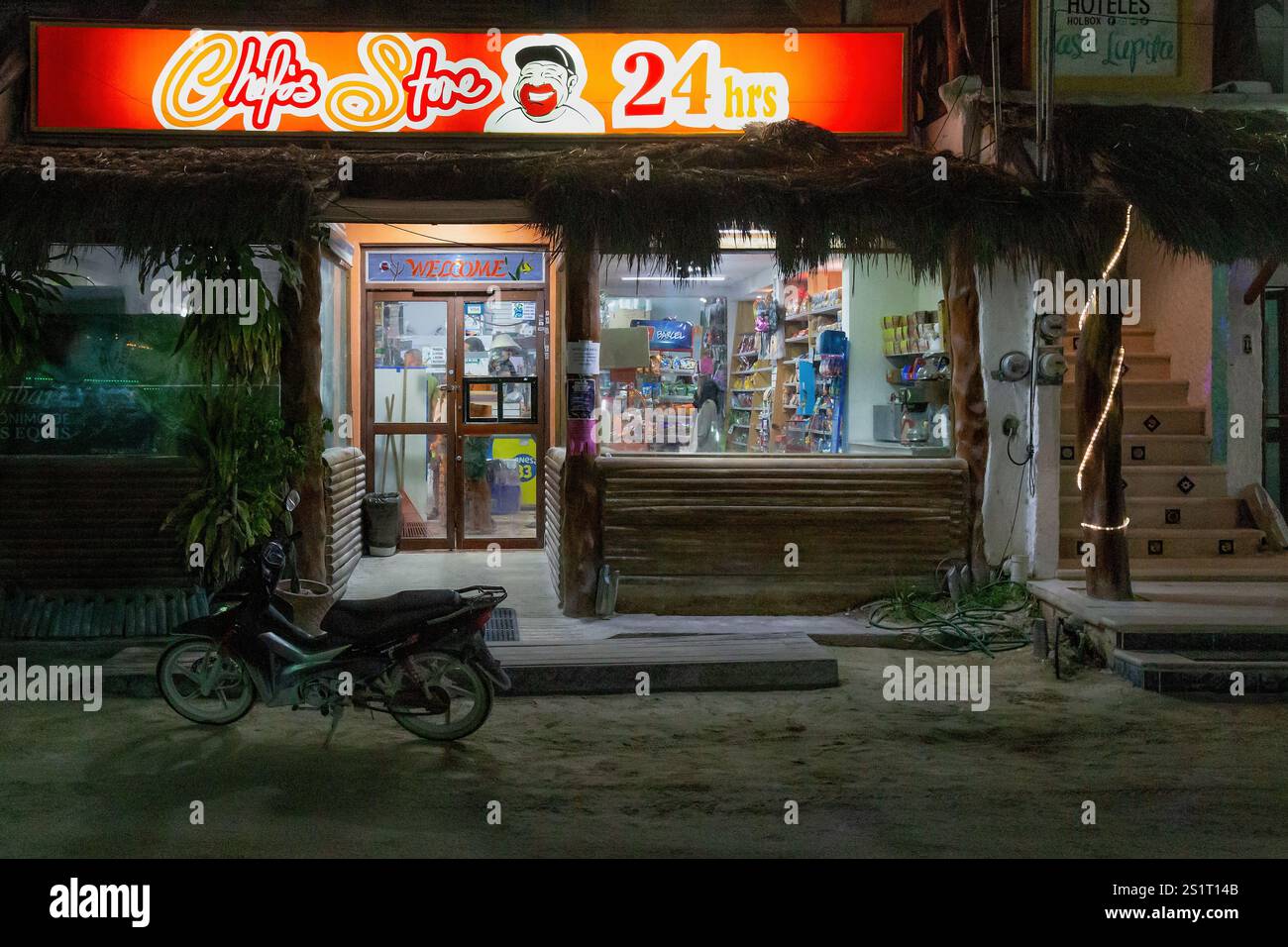 24-Hour Convenience Store Exterior with Illuminated Signage at Night ...