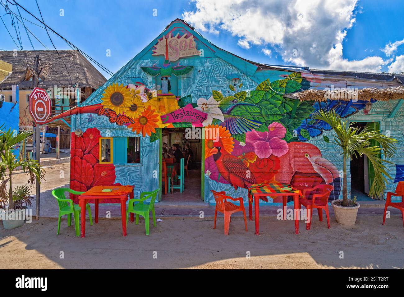 Colorful Outdoor Cafe With Vibrant Artwork and Rustic Decor on a Sunny ...