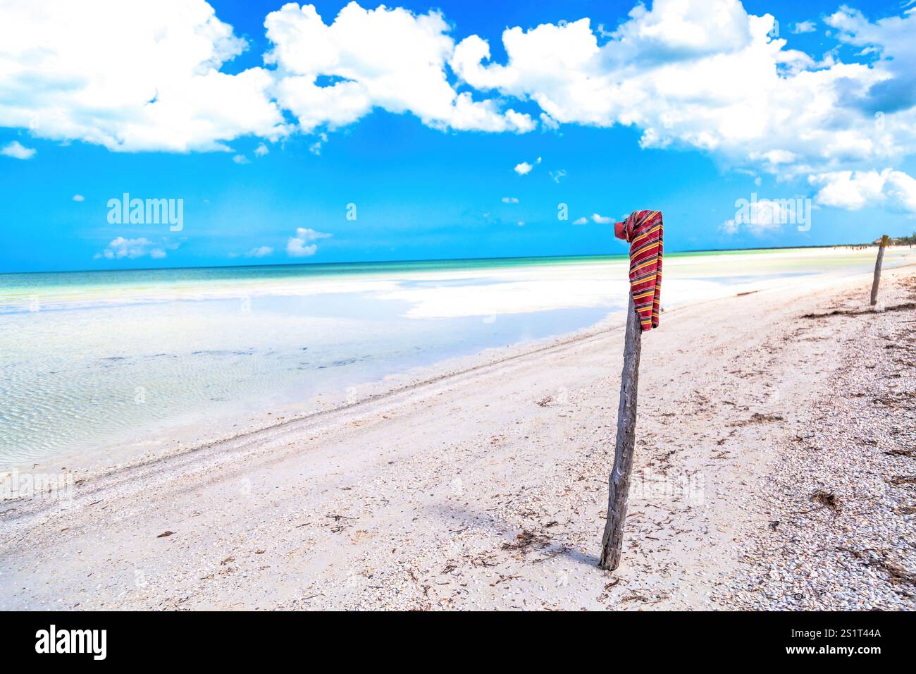 Serene Beach Scene With Vibrant Cloth on Post Amid Blue Skies, Isla ...