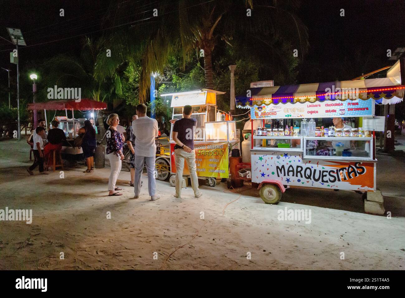 People Enjoy Street Food at An Outdoor Vendor Stall at Night, Isla ...