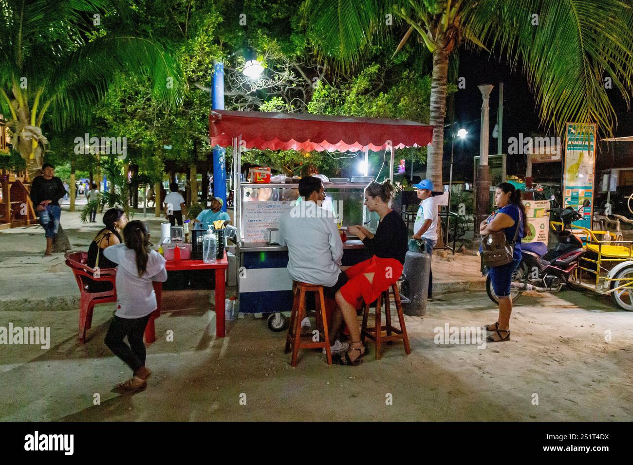 People Enjoy Street Food at An Outdoor Vendor Stall at Night, Isla ...